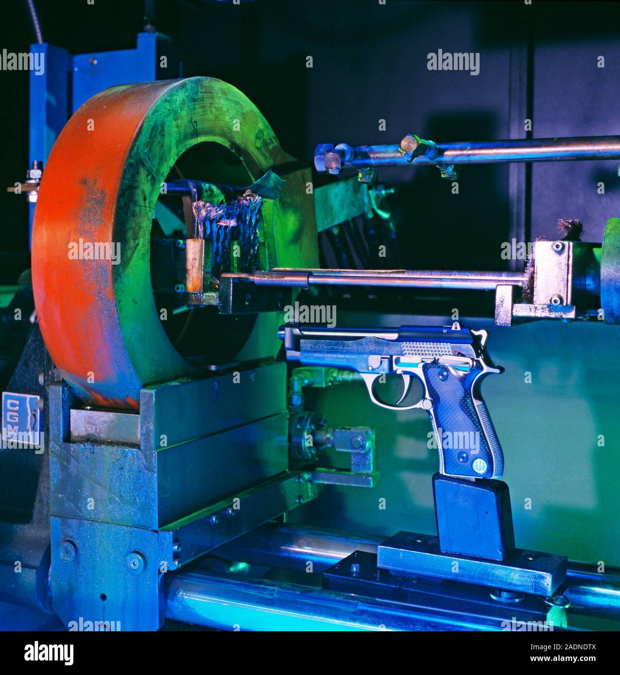 Quality control. Testing the barrel of a beretta 92F 9mm semi-automatic ...