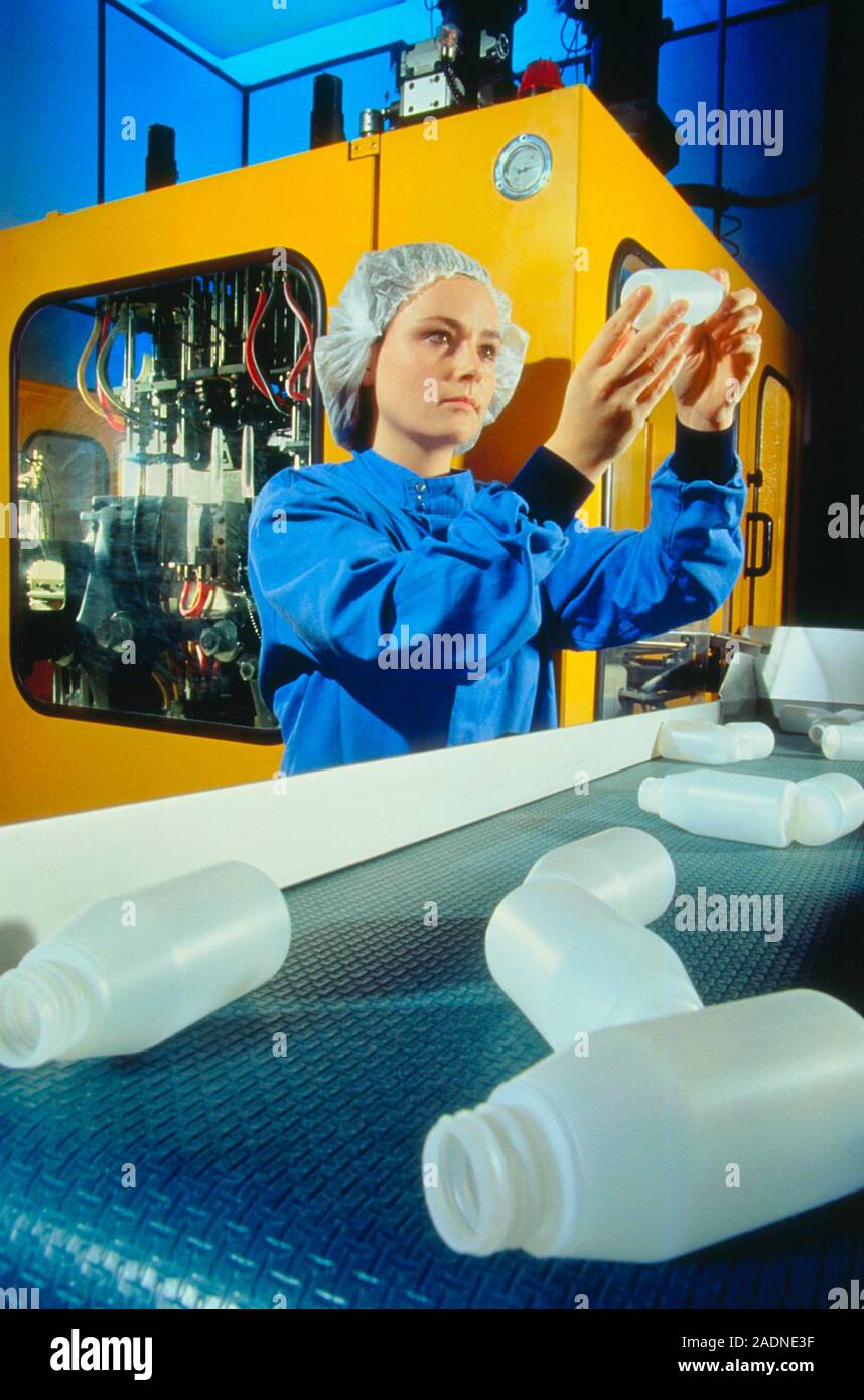 Visual quality control. A production operator examining a plastic blow ...