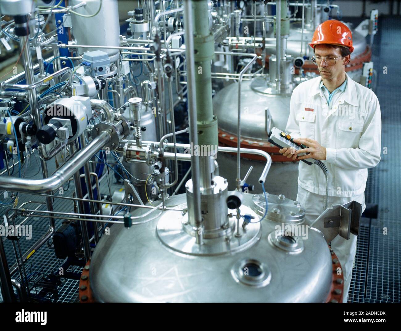 Bioreactor food production. Worker with bioreactors used to produce ...