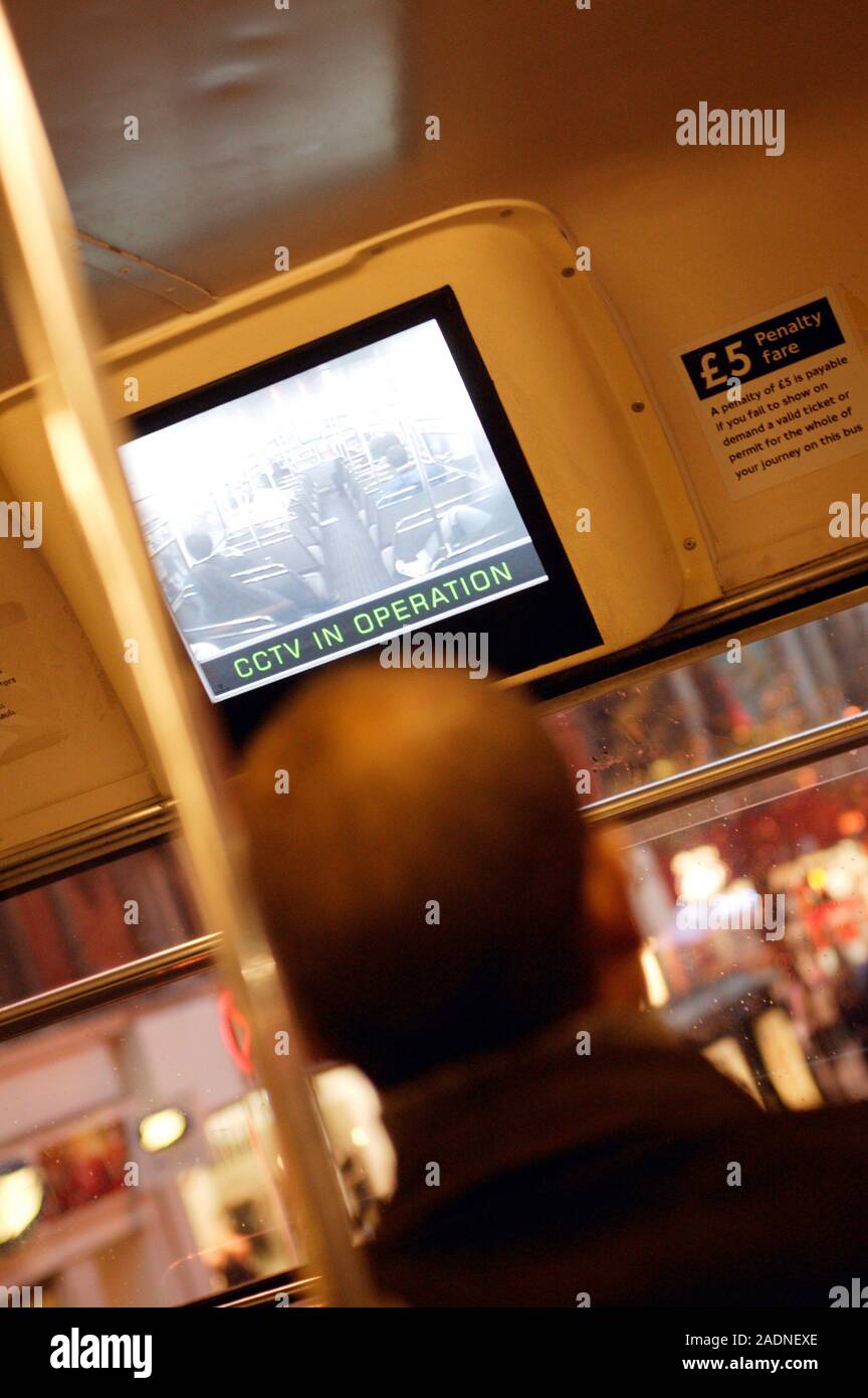 CCTV camera (upper left) on the top deck of a London bus. A passenger ...