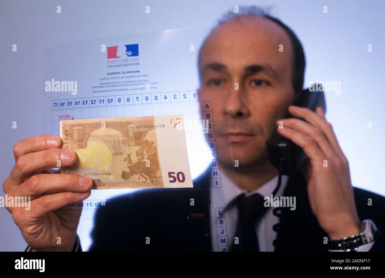 Banknote security. Image 2 of 2. Civil servant using a standard ...