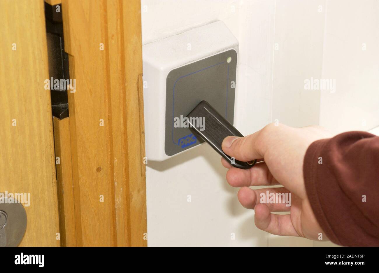 Door security system. Person swiping a radio frequency programmed key ...