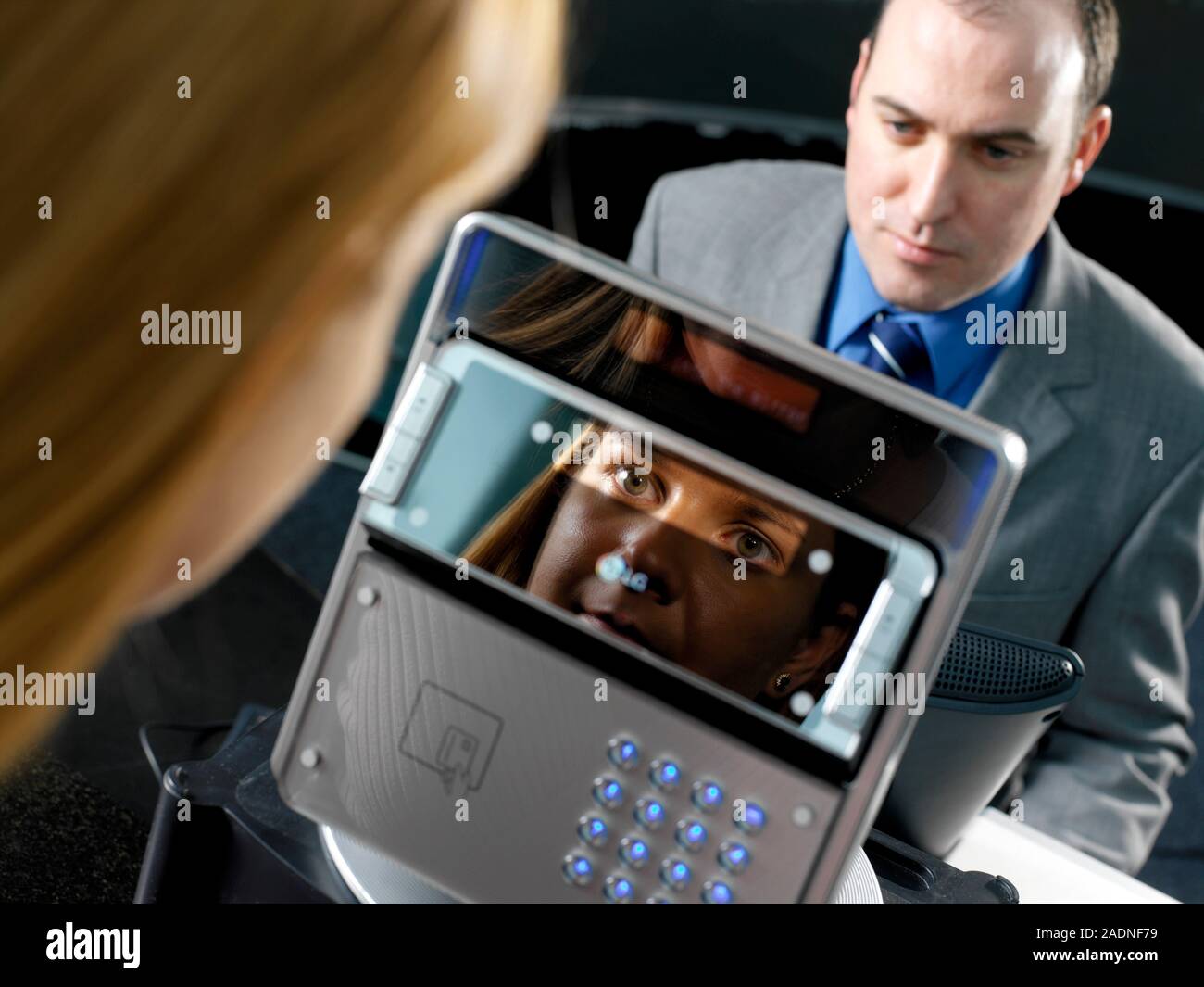 Biometric eye scanning. Woman having her eyes screened by a biometric ...