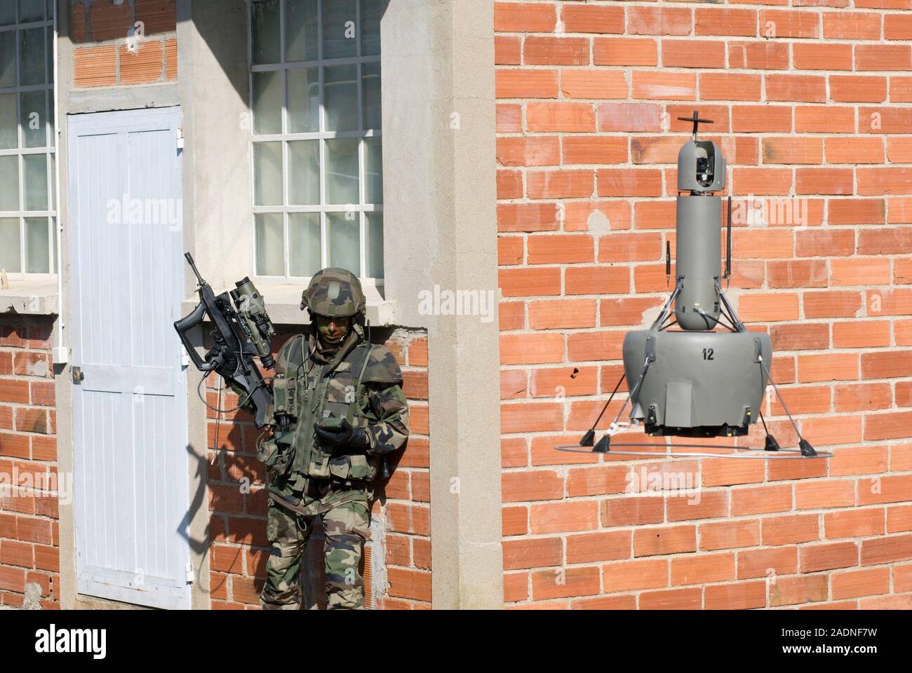 Military mini-UAV. Soldier using the FELIN infantry combat system. The ...