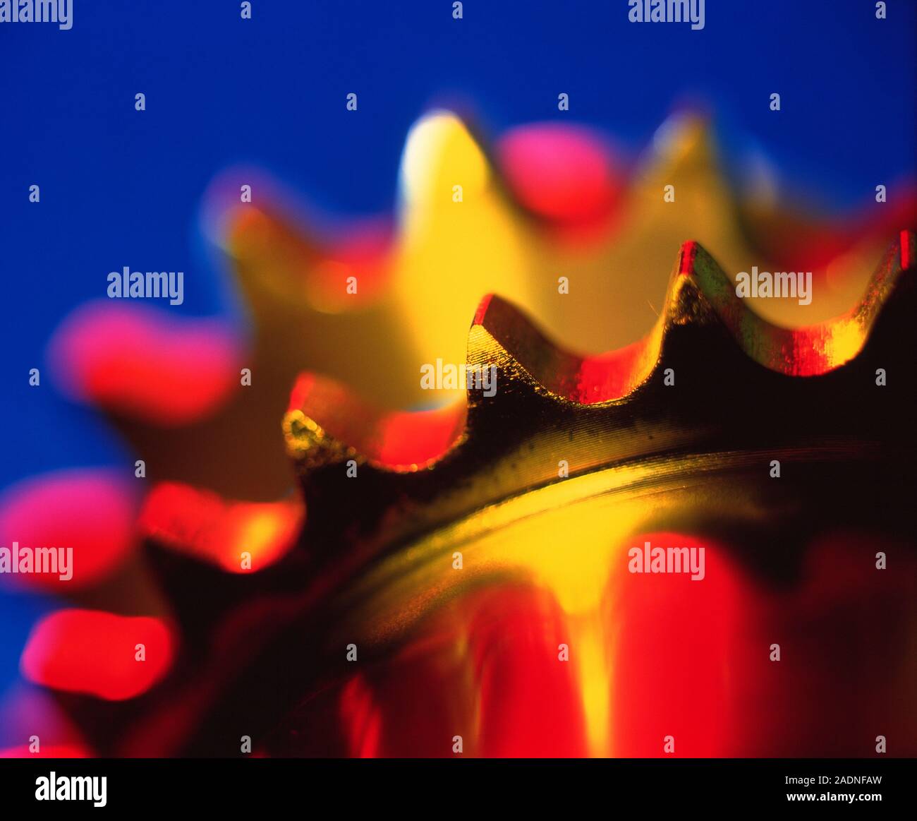 Cogs. View of a cog from a gear system with another seen blurred in the ...