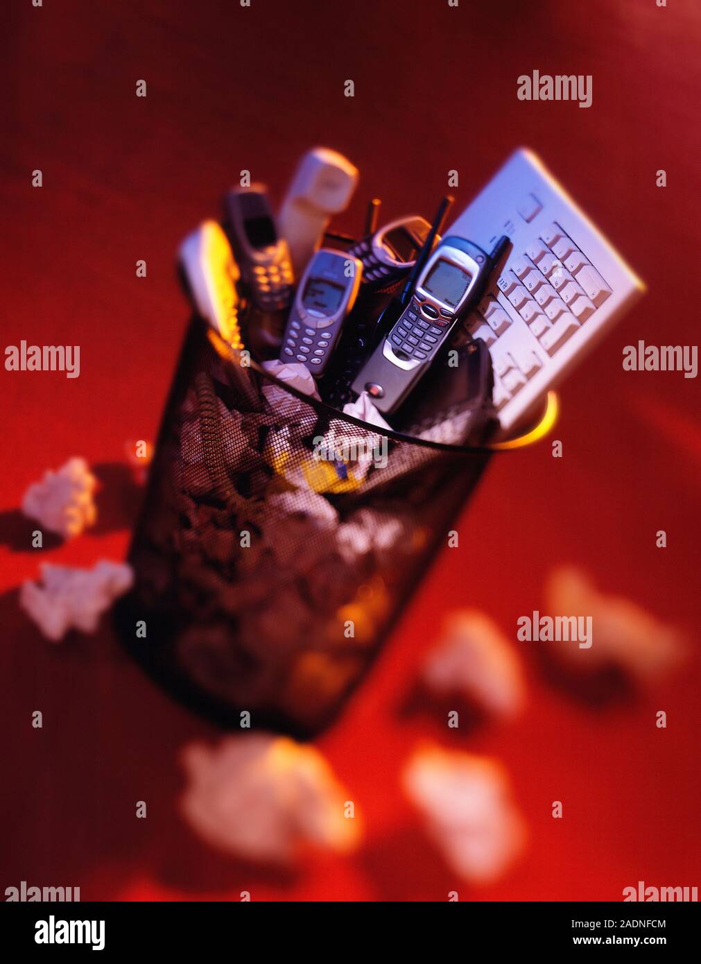 Obsolete technology. Mobile phones and a computer keyboard in a rubbish ...