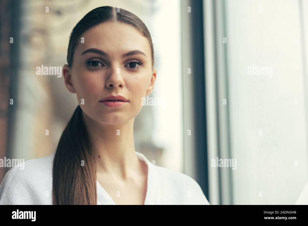 Portrait of calm long haired woman standing alone Stock Photo - Alamy