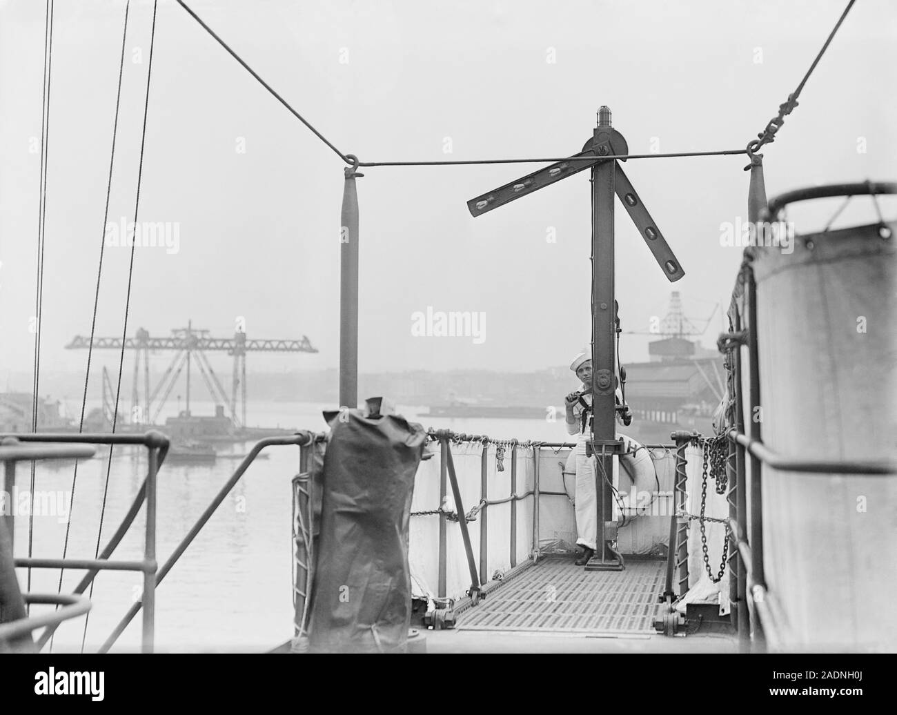 Naval semaphore signalling. Sailor operating a semaphore signalling ...