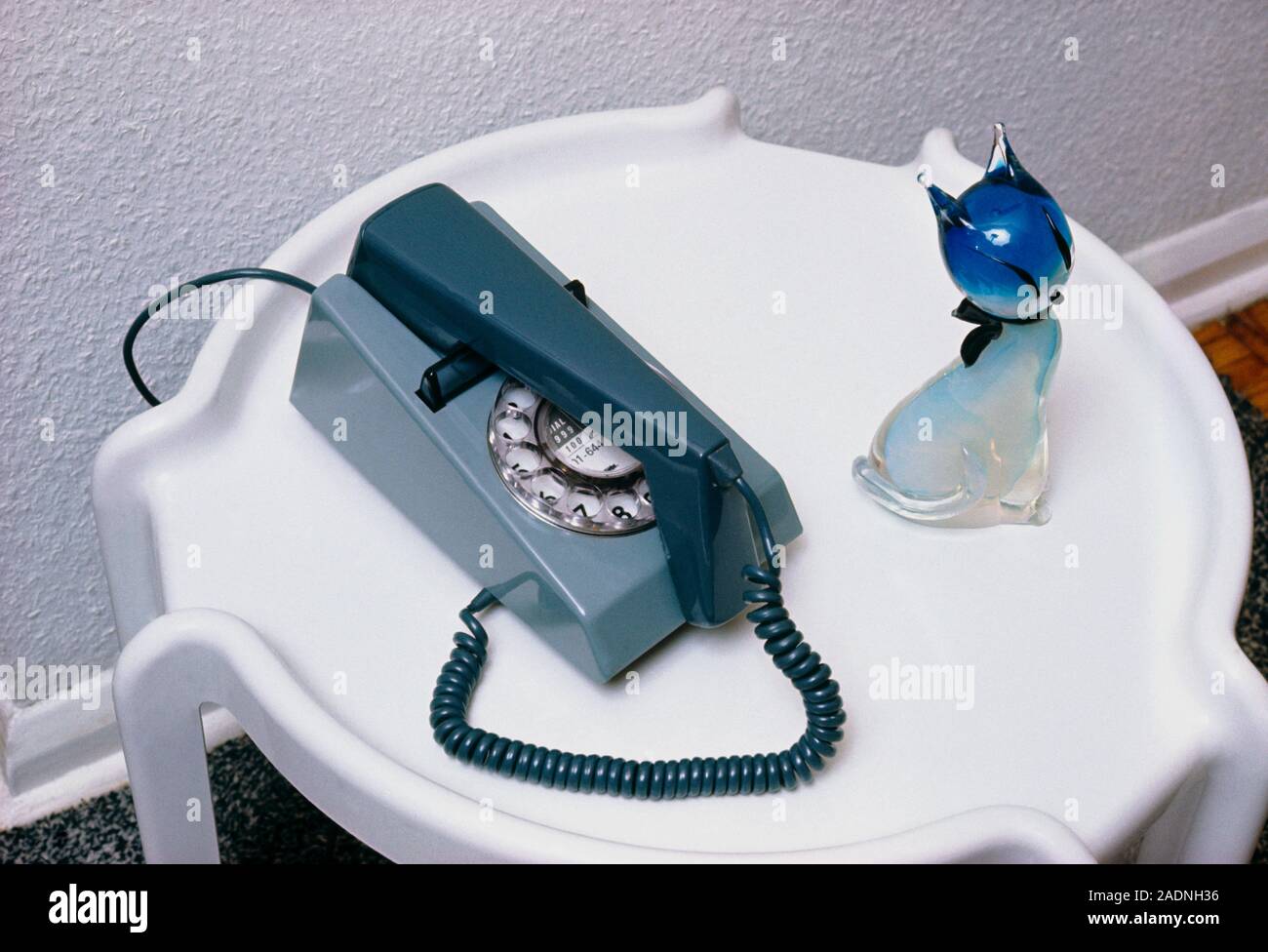 1960s telephone on a table. This telephone, known as a trimphone, is a ...