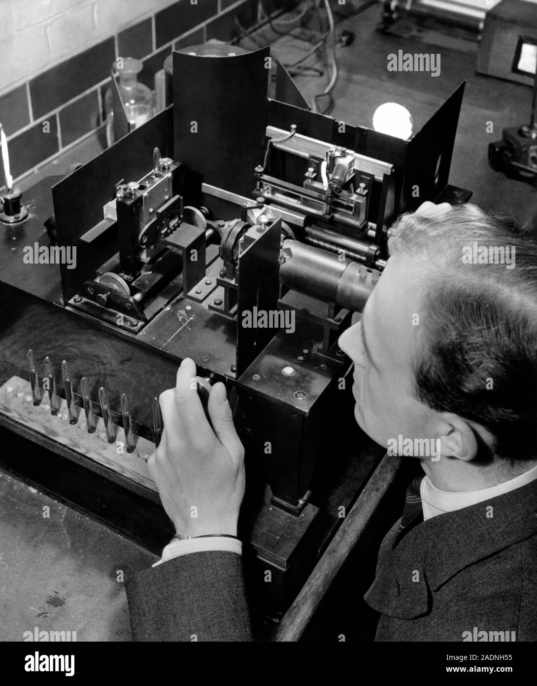 Haemoglobin blood test. Researcher using optical equipment to test for ...