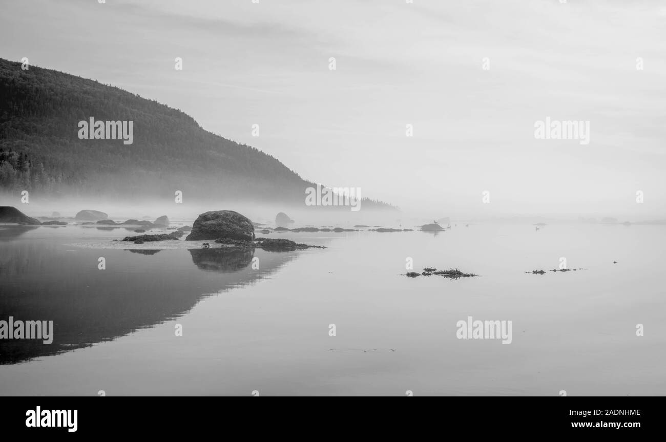 Calm ocean rocks blue sky Black and White Stock Photos & Images - Alamy