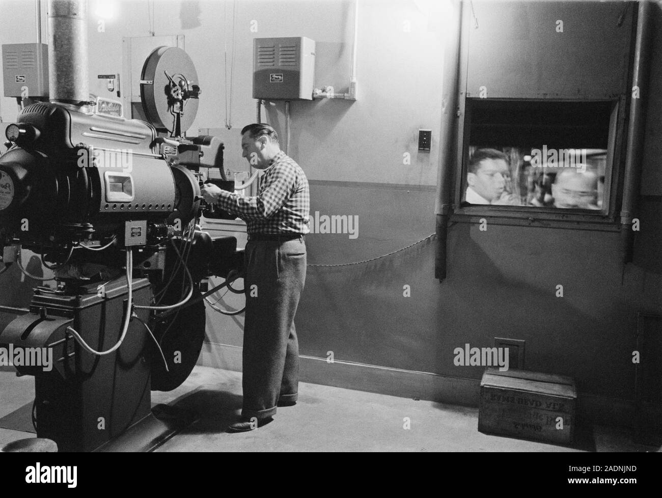 1950s film projector. Projectionist at work in a cinema, photographed ...
