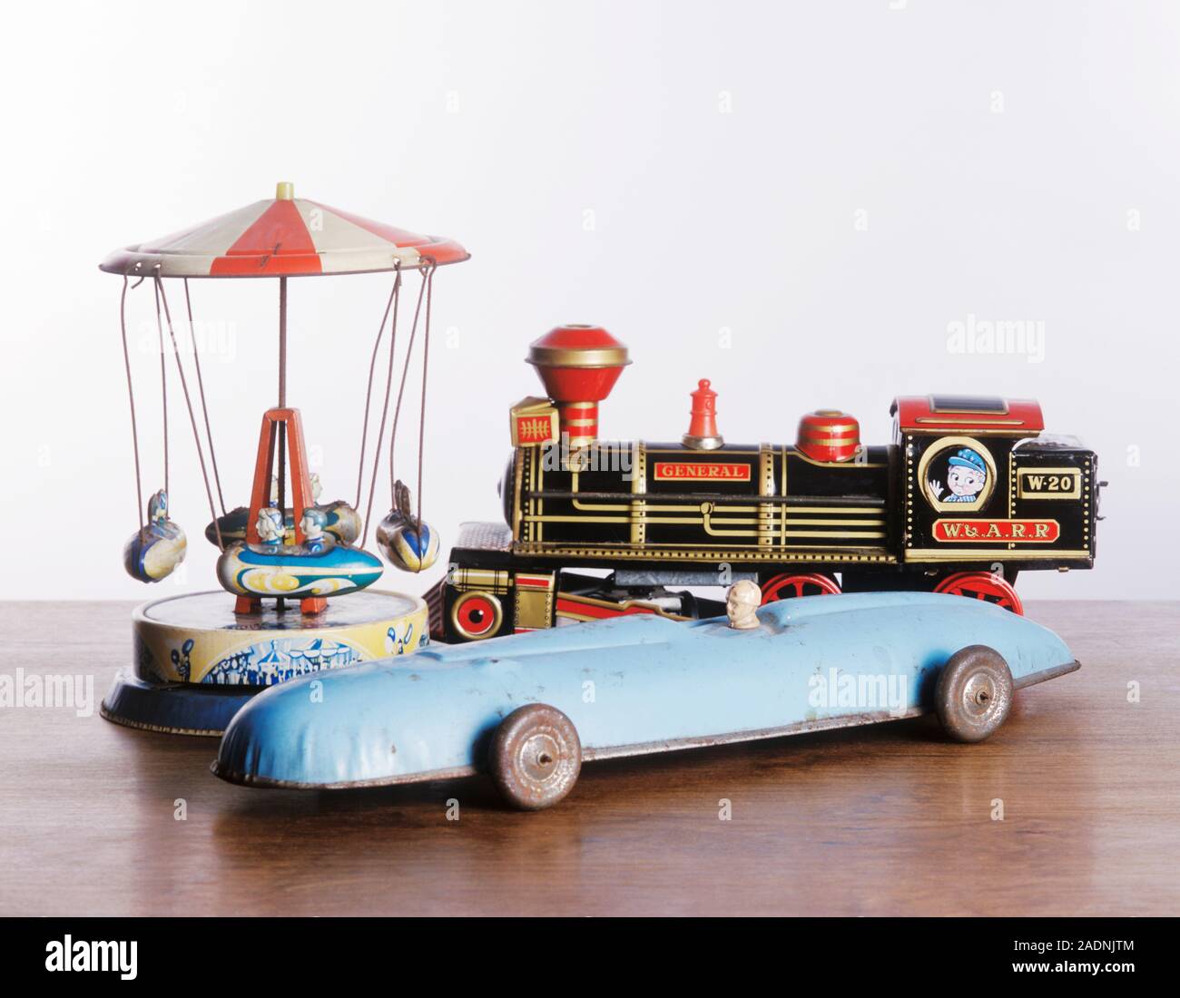 Antique toys. Tin models of a train, racing car and merry-go-round ...