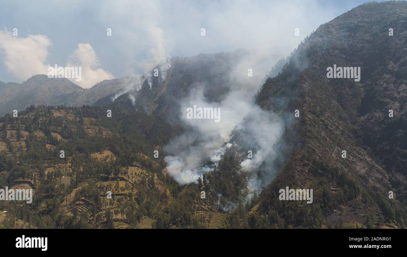 fire in mountain forest. aerial view forest fire and smoke on slopes ...