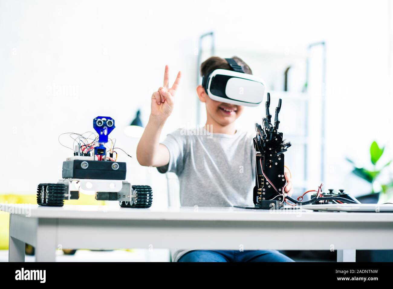 Joyful smart boy making experiments with robotic humanoid hand Stock ...