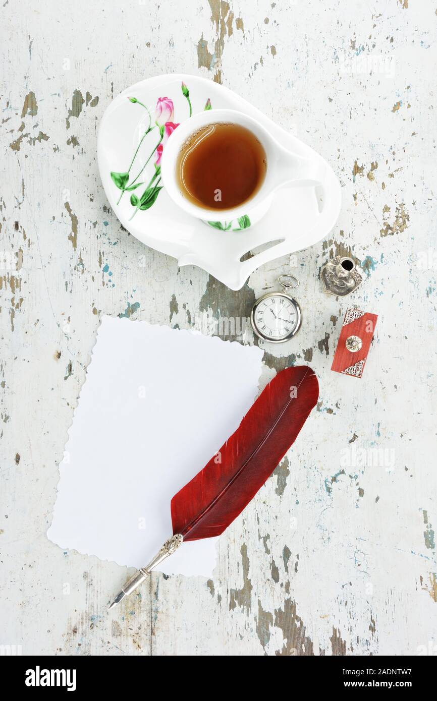 Quill pen with deep red feather, quill stand,a blotter,a blank paper ...