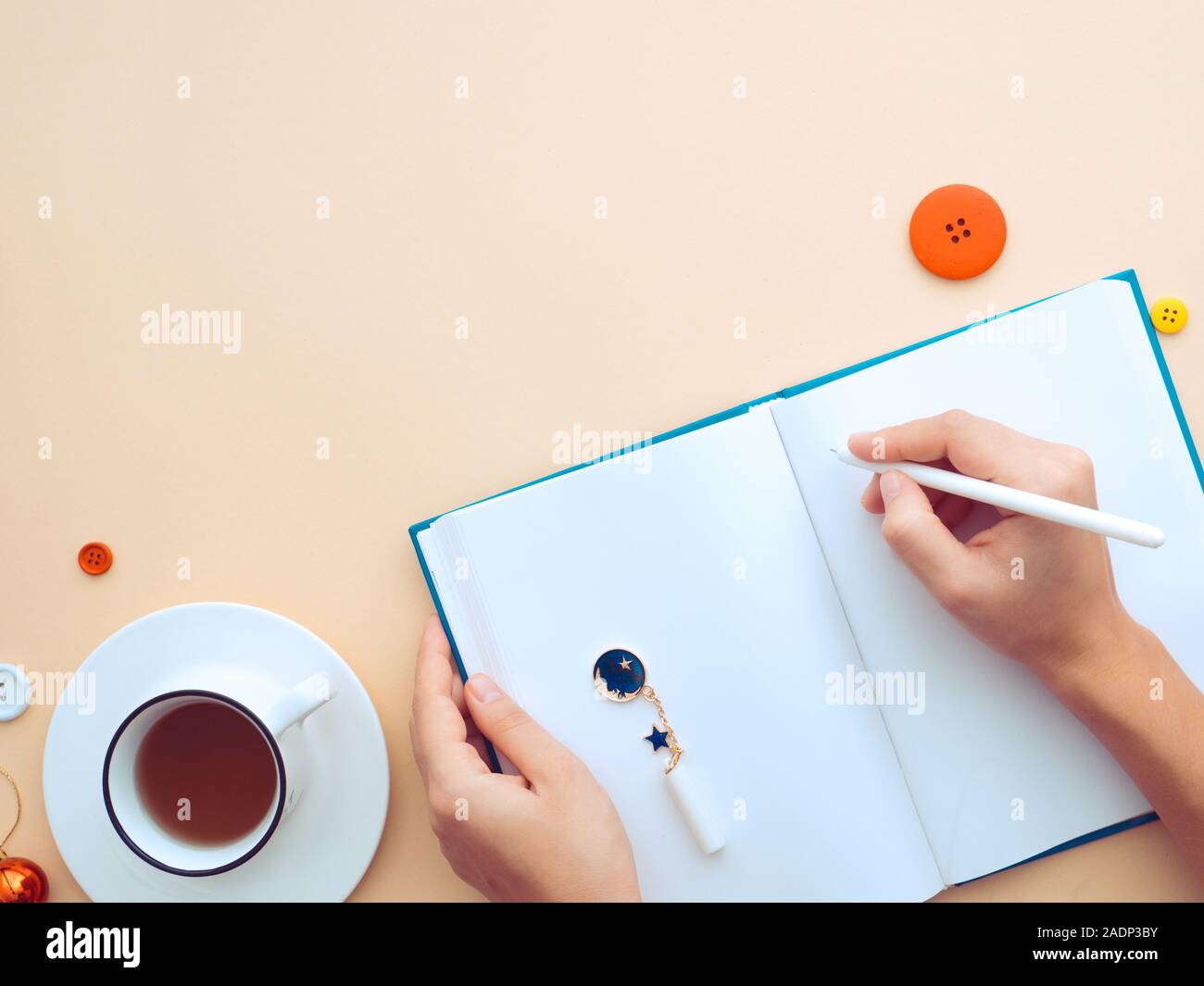 Woman's hand writing in notebook decorated with Christmas decorations ...