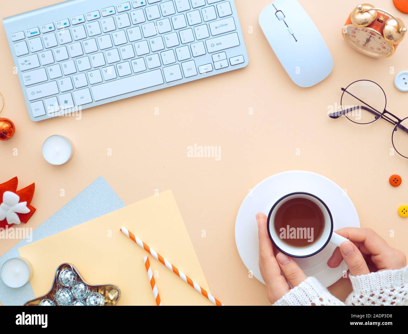 Christmas female hands holding tea cup on a desk with blank paper note ...