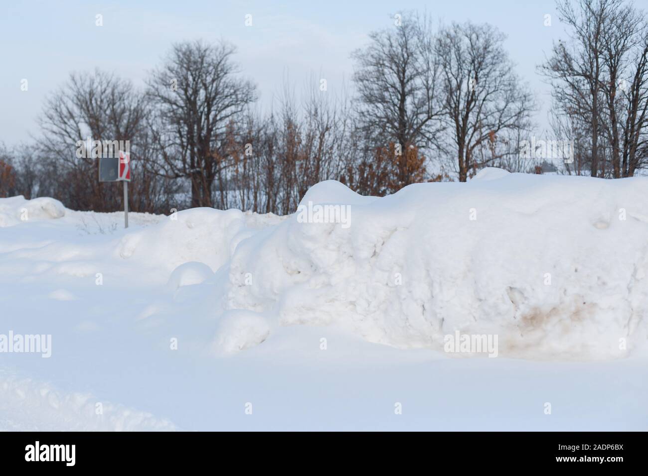 Winter poorly cleared road. Road in the countryside strewn with snow ...