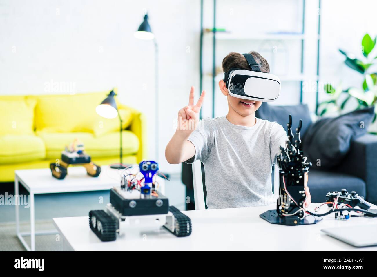 Optimistic little boy testing his robotic creation Stock Photo - Alamy