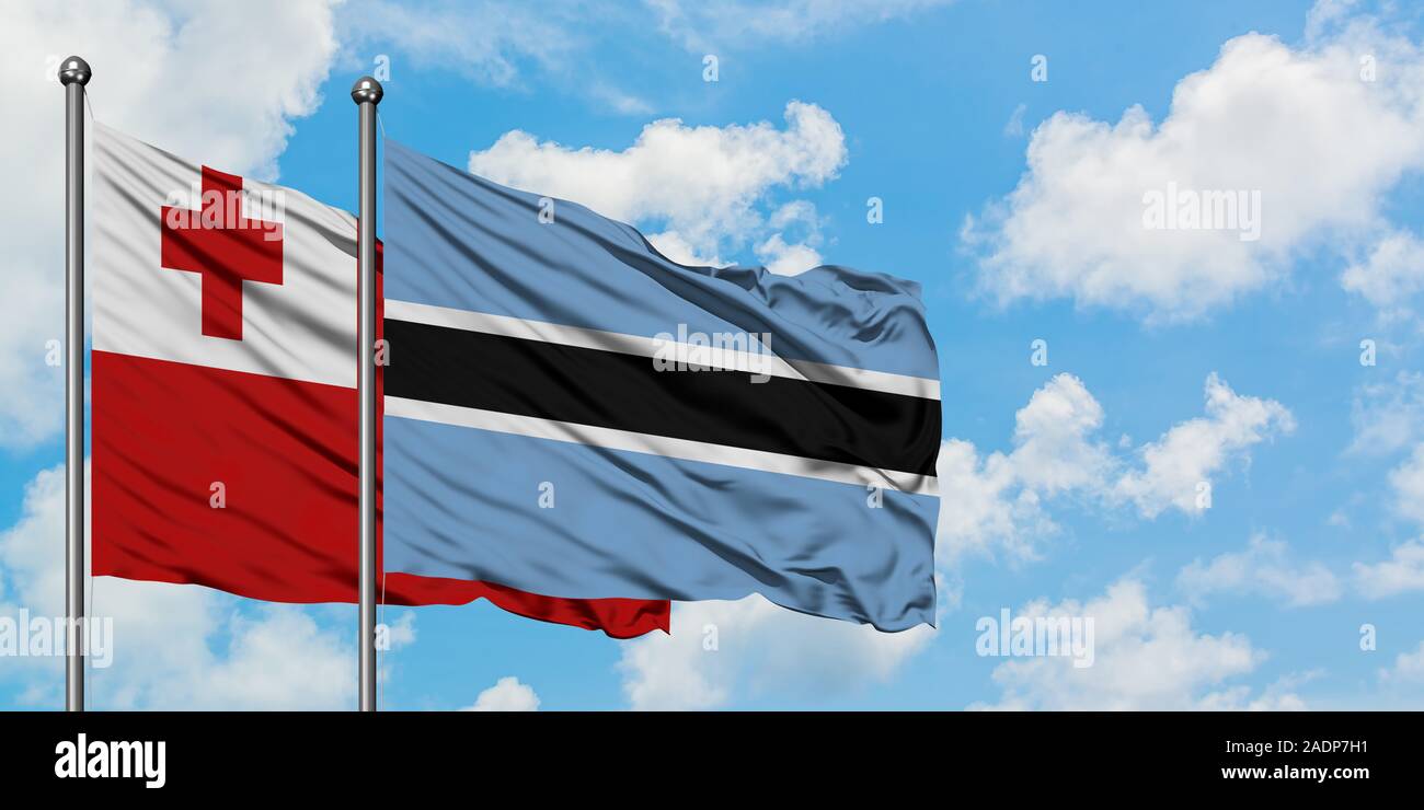 Tonga and Botswana flag waving in the wind against white cloudy blue ...