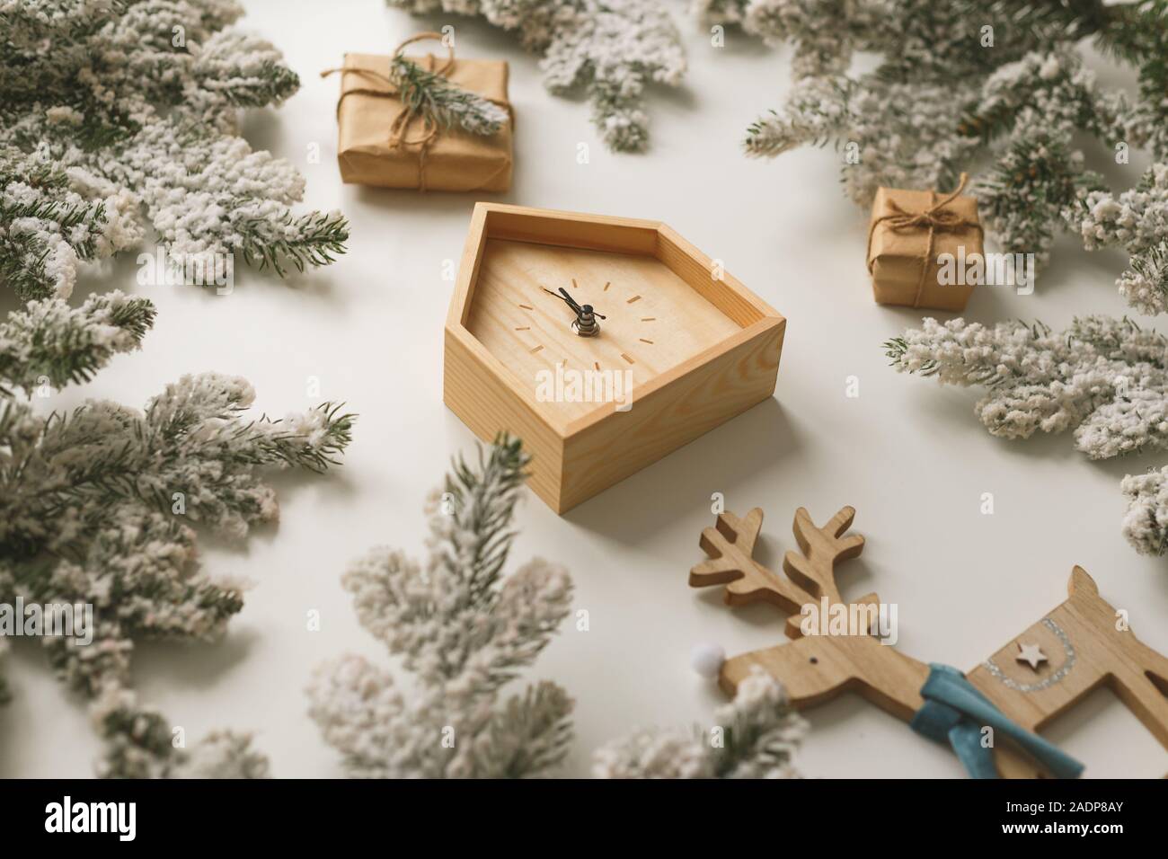 Christmas and New Year still life. Wooden clock shows five minutes to ...