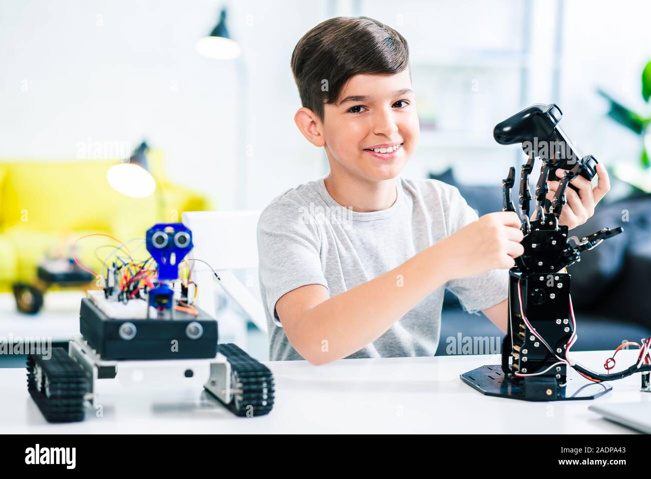 Cheerful smart boy testing his humanoid robotic hand Stock Photo - Alamy