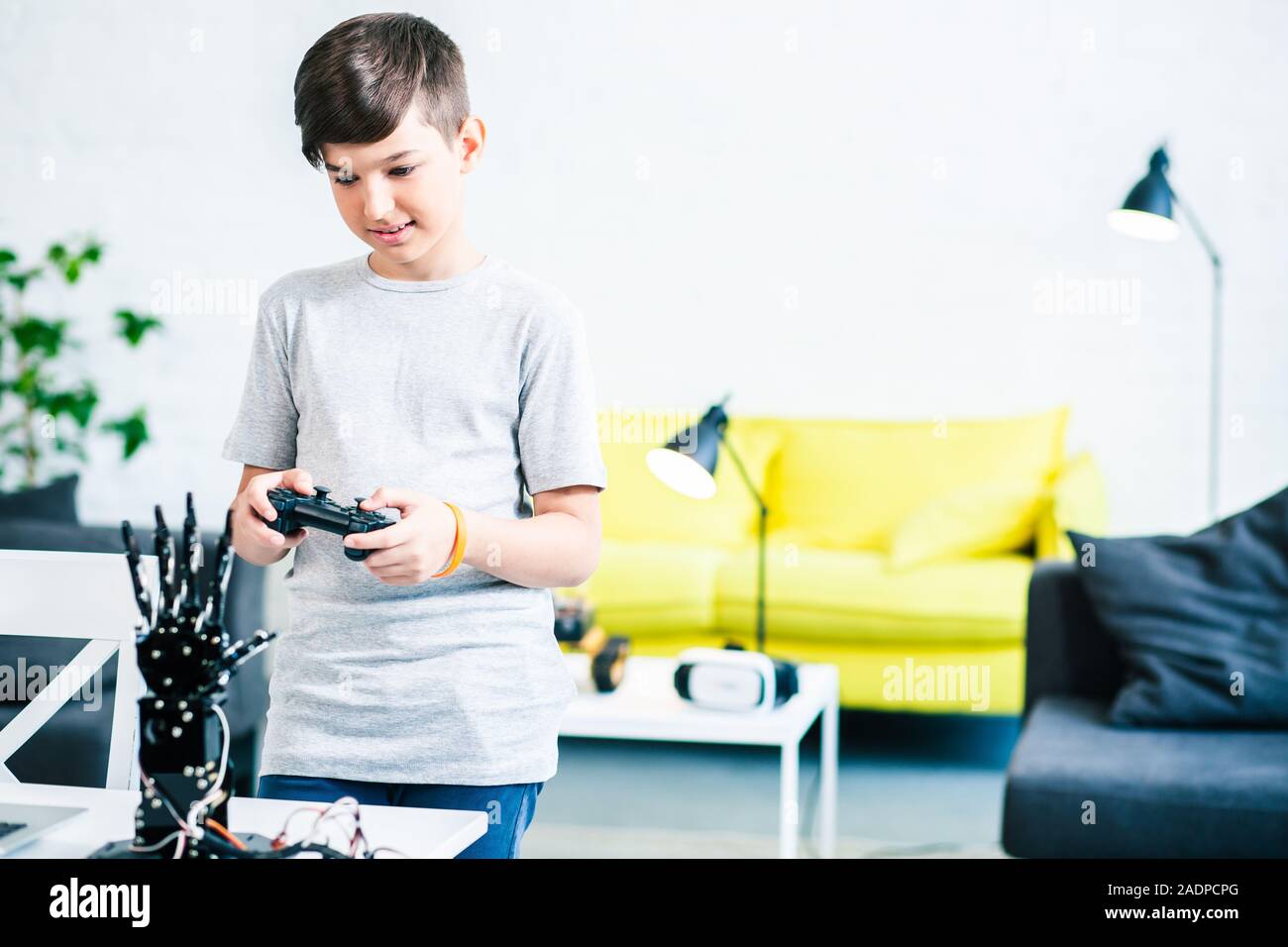 Ingenious young boy controlling his modern device Stock Photo - Alamy