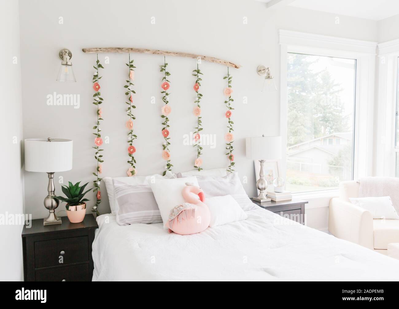 Floral garland hanging over bed Stock Photo - Alamy