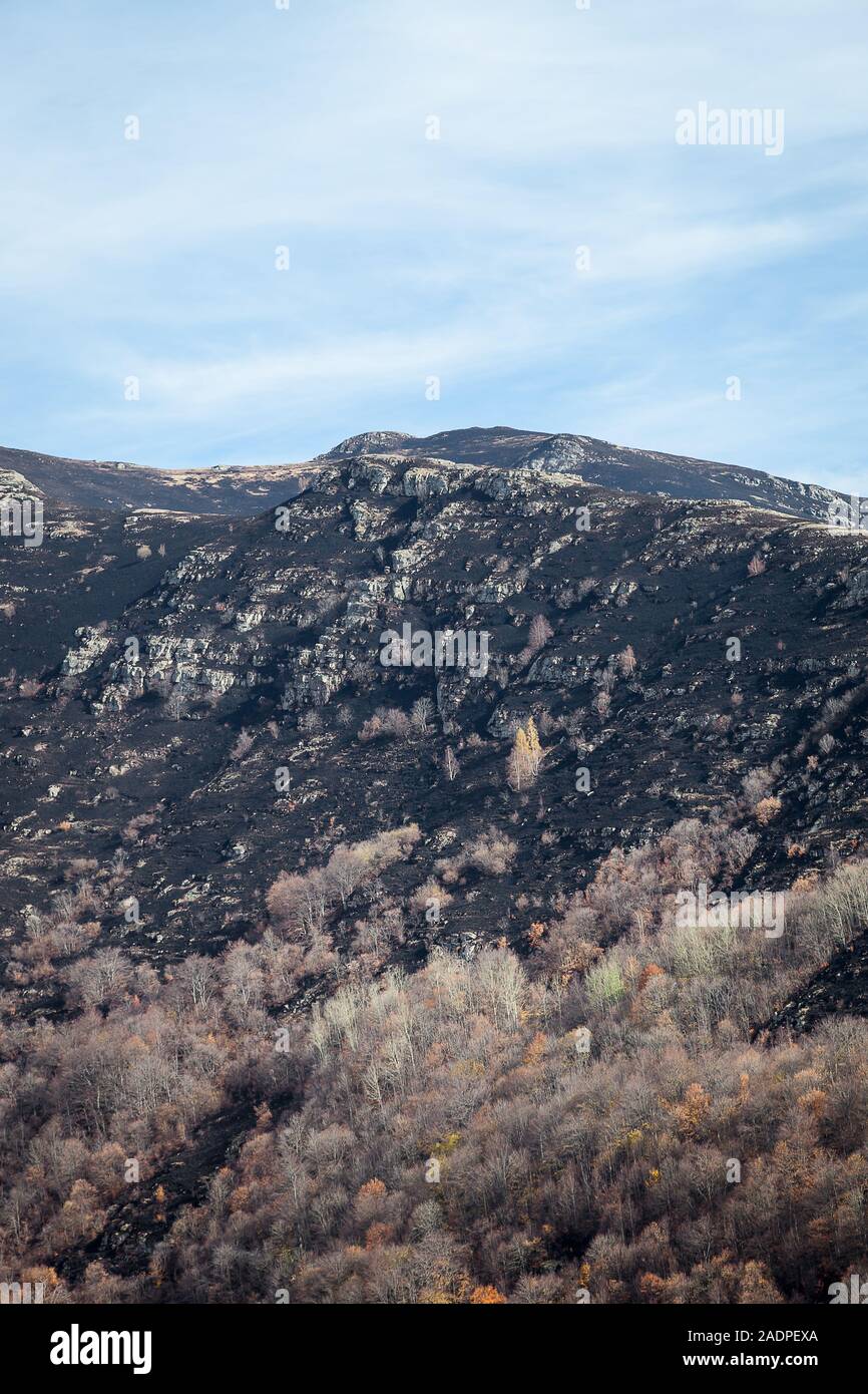 Dark, scorched, burnt ground on the highlands of a mountain, autumn ...