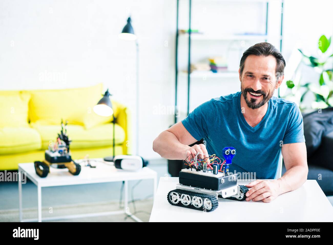 Positive adult man enjoying his engineering hobby at home Stock Photo ...