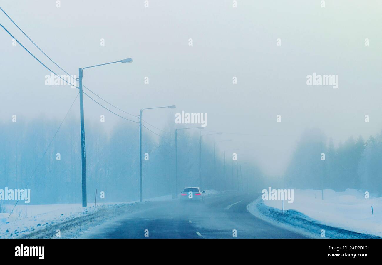 Car in the road in mist in winter Rovaniemi reflex Stock Photo - Alamy