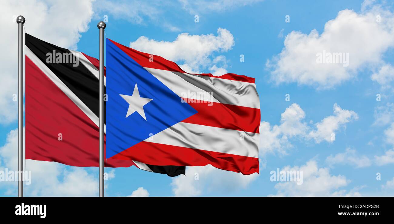 Trinidad And Tobago and Puerto Rico flag waving in the wind against ...