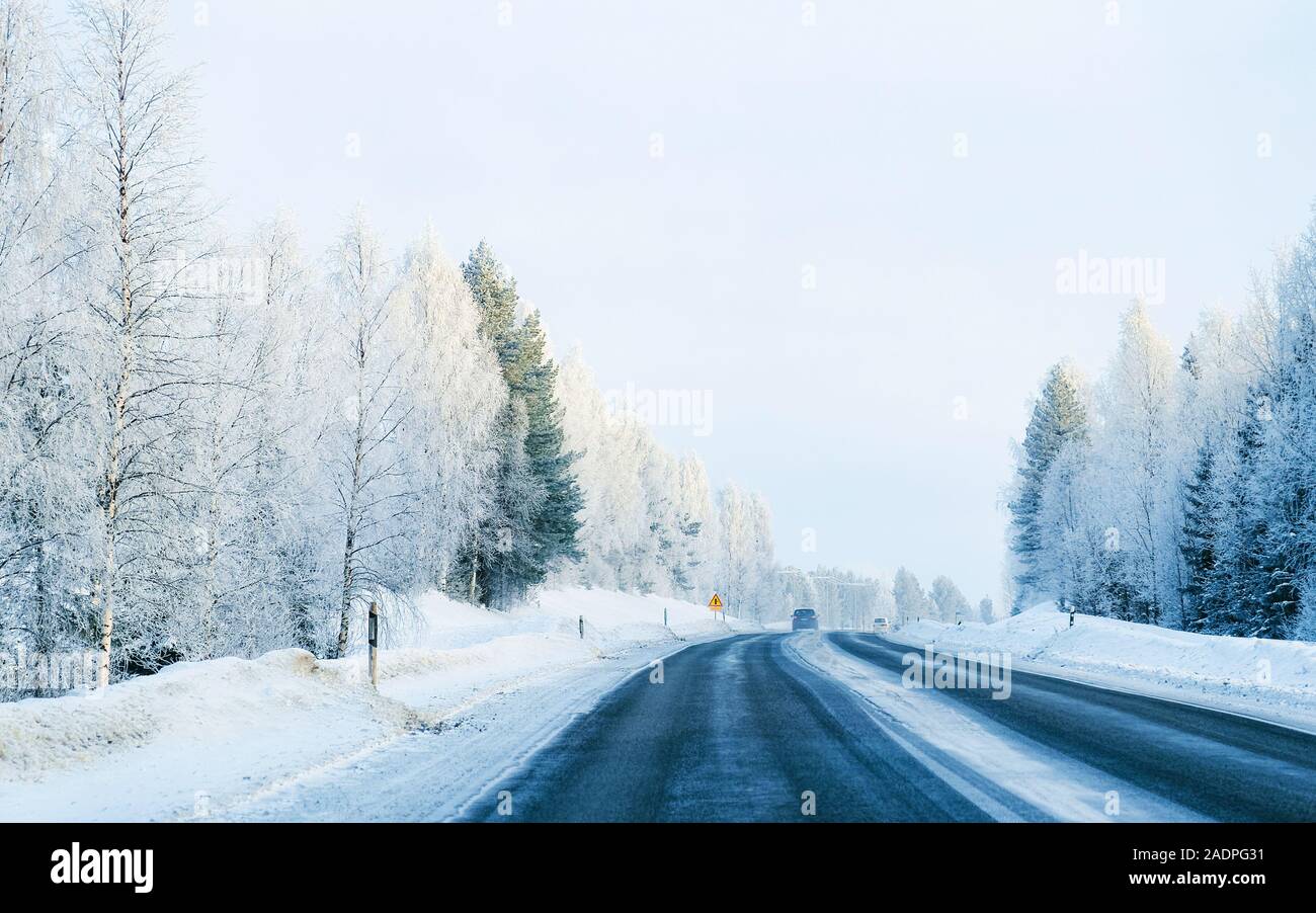 Winter road and Snowy Forest at Cold Finland reflex Stock Photo - Alamy