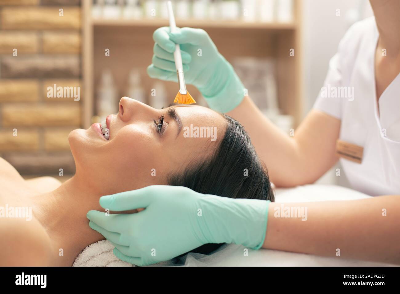Side view photo of the woman having peeling procedure Stock Photo - Alamy