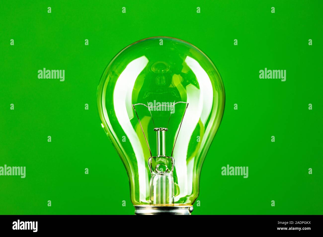 Classic light bulb on green background Stock Photo - Alamy