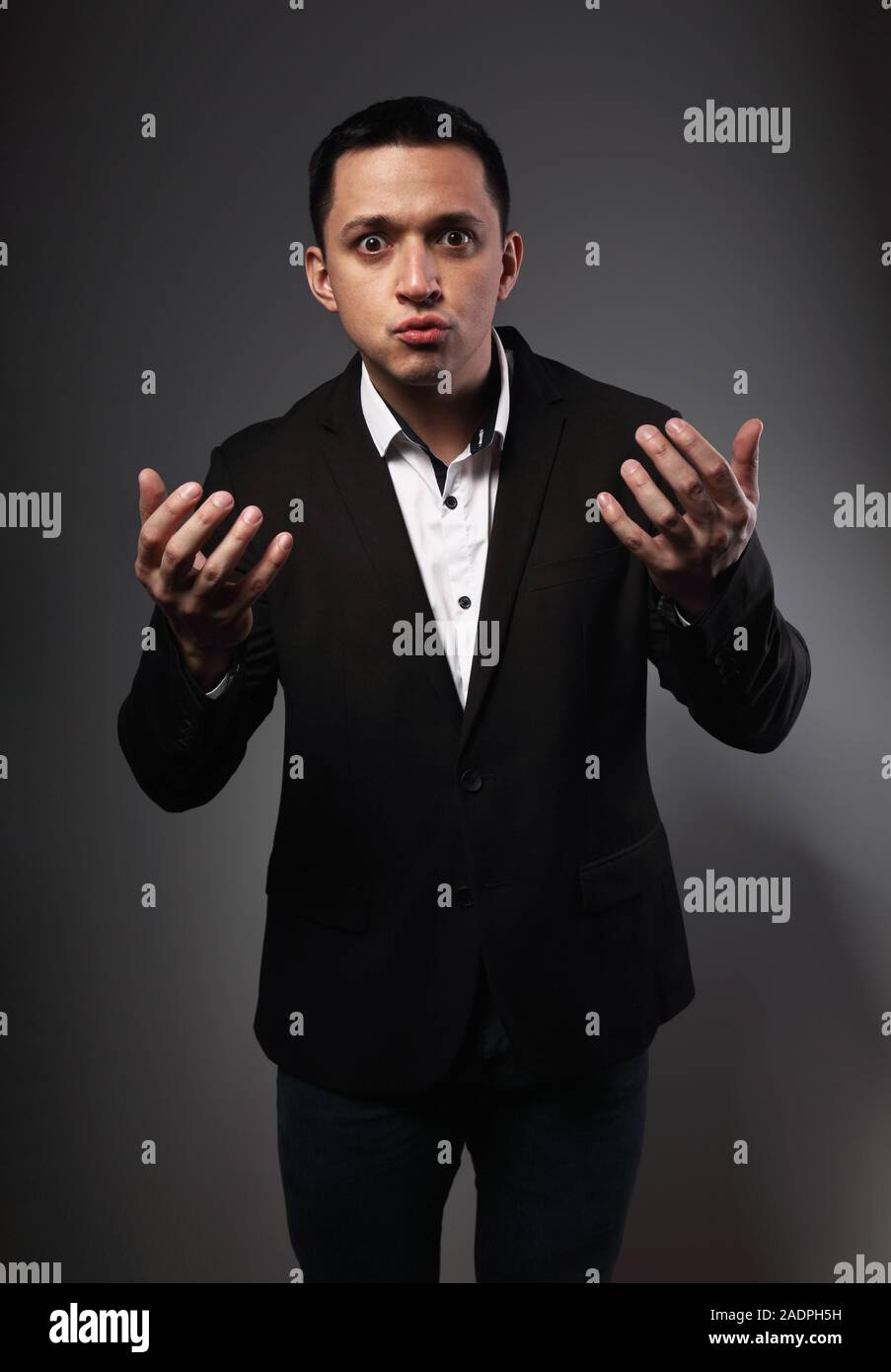 Angry business man in suit explain the question and gesturing the hands ...