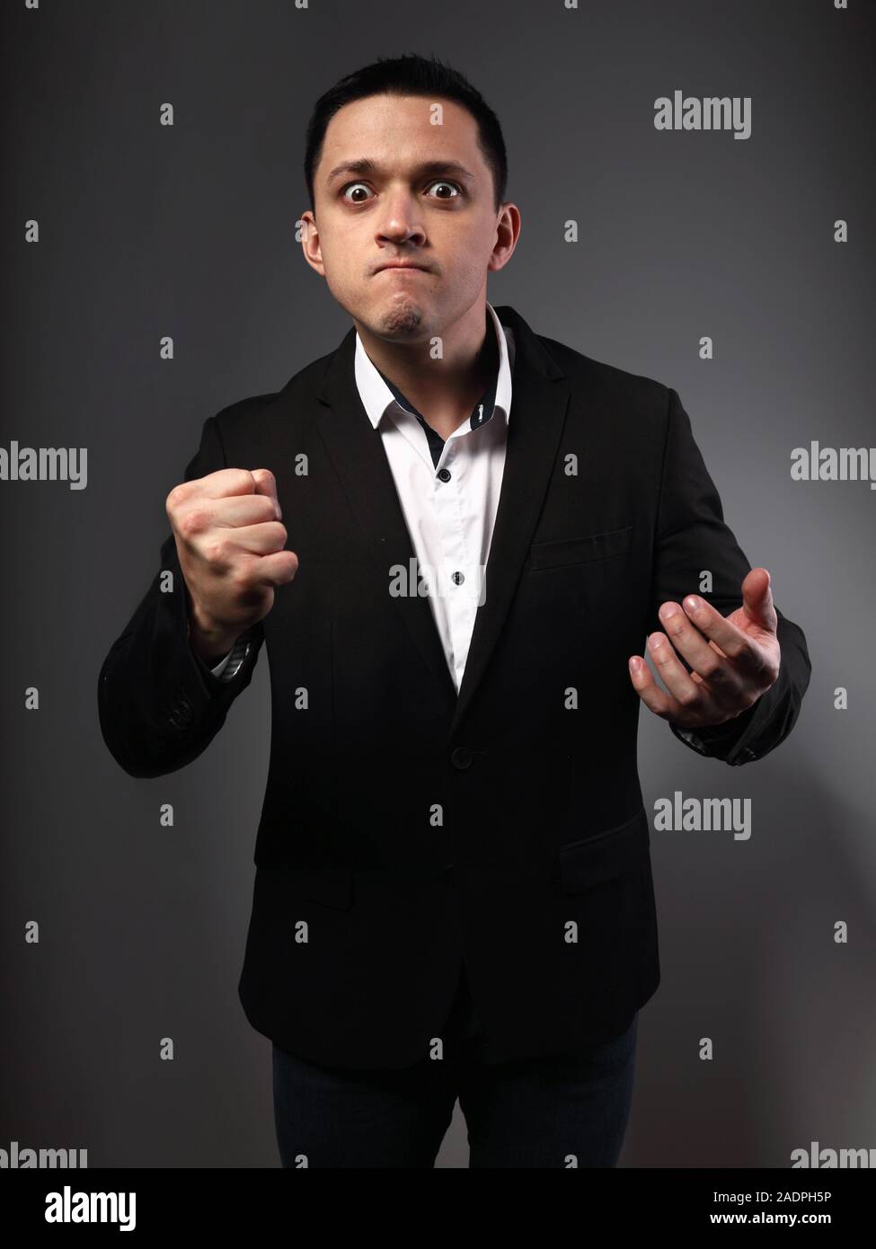 Angry mad business man fighting and gesturing the fist and on grey ...