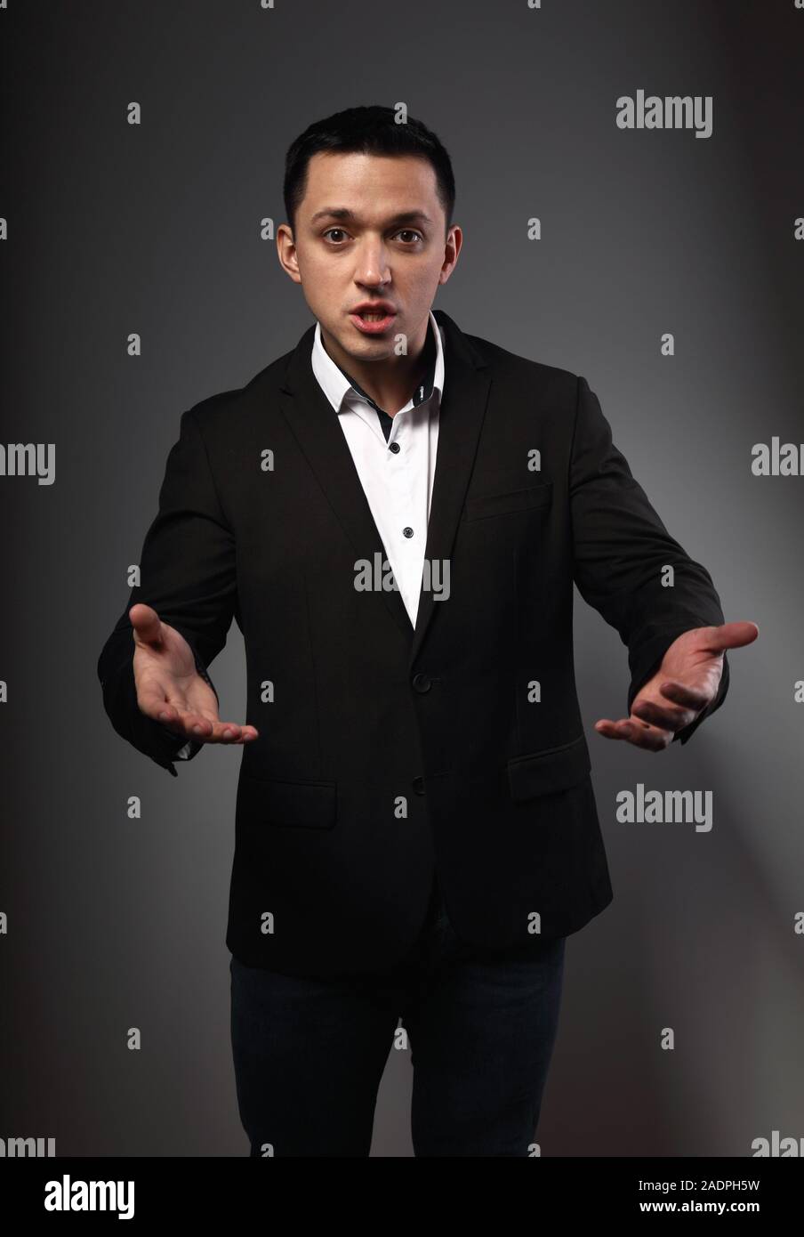 Angry business man in suit explain the question and gesturing the hands ...