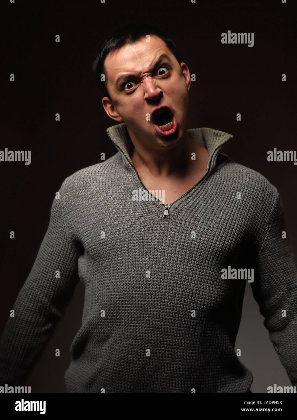 Angry zombie man looking with aggressive eyes and wide opened mouth ...