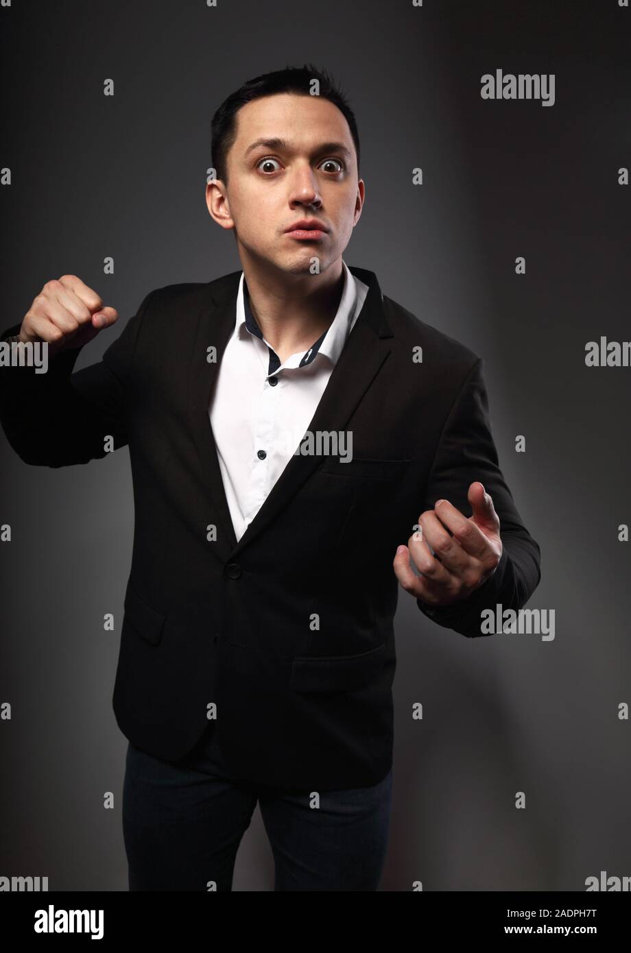 Angry mad business man fighting and gesturing the fist and on grey ...