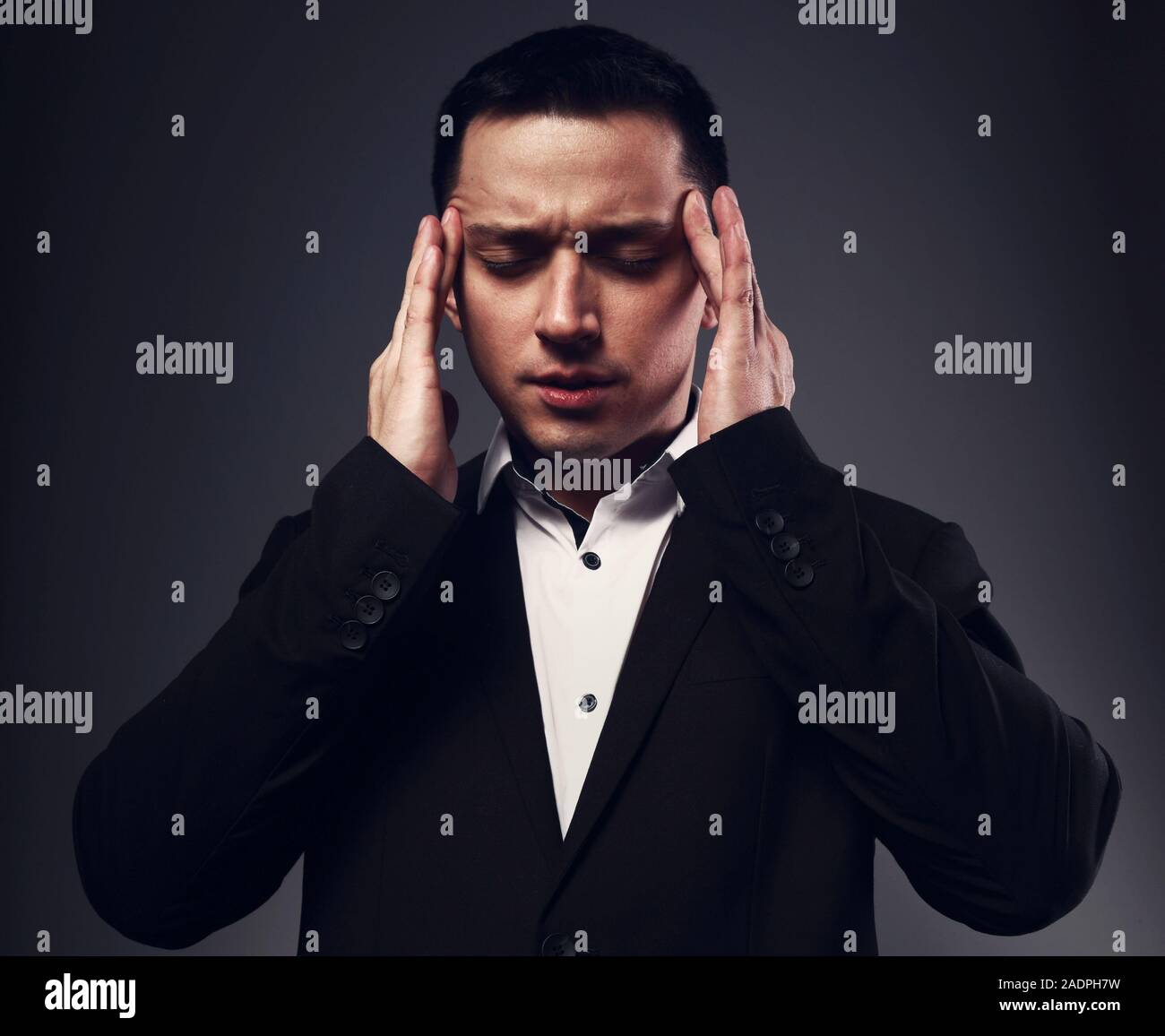 Serious thinking man with thought-transference abilities holding the ...