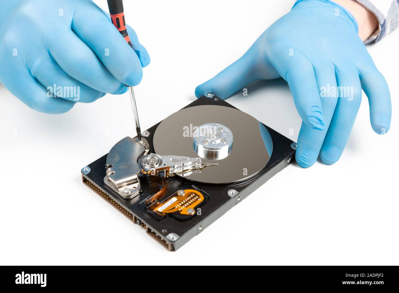Men's hands in blue gloves repairing dismantled hard drive. Computer ...