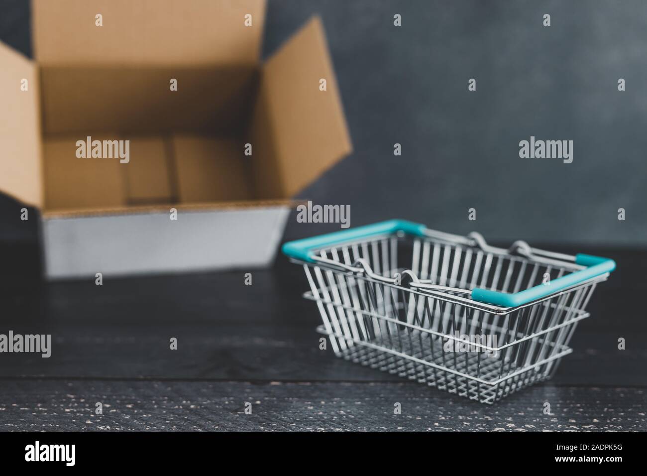 online shopping conceptual still-life, empty parcel and shopping basket ...