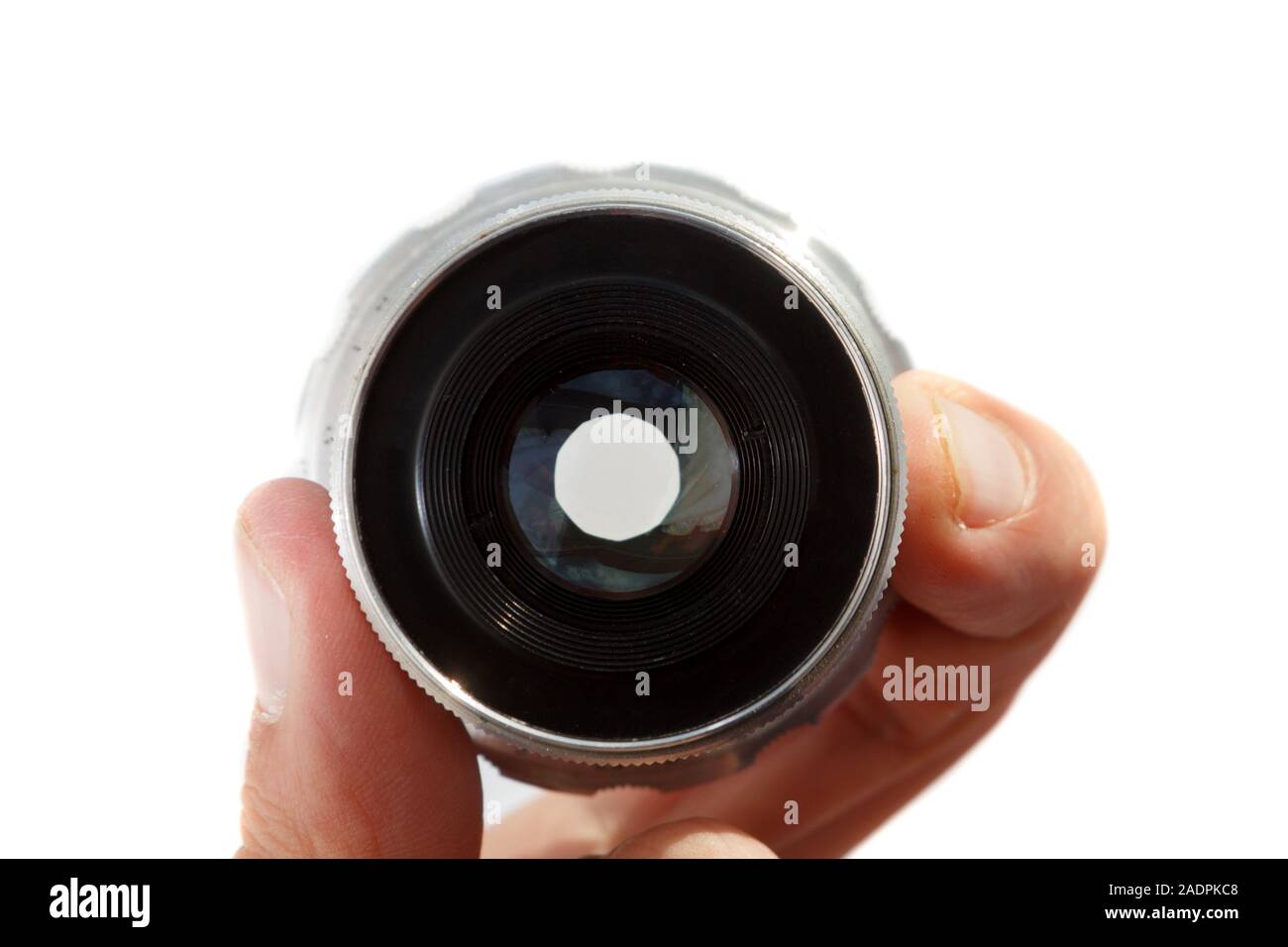 Hand holding retro camera lens on white background Stock Photo - Alamy