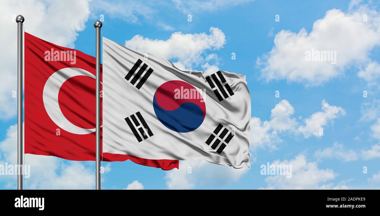 Turkey and South Korea flag waving in the wind against white cloudy ...
