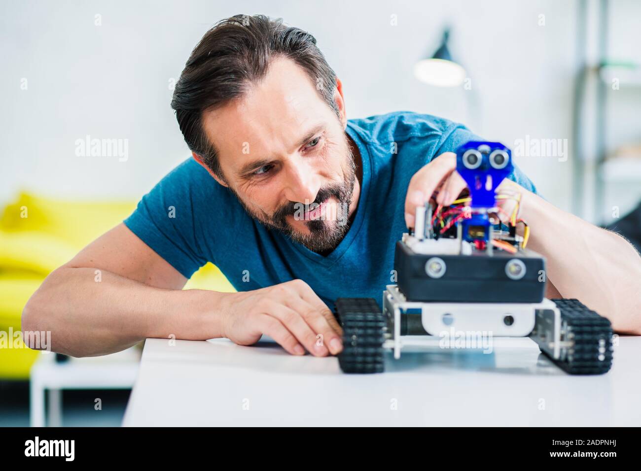 Positive adult man being involved in robotic technologies Stock Photo ...