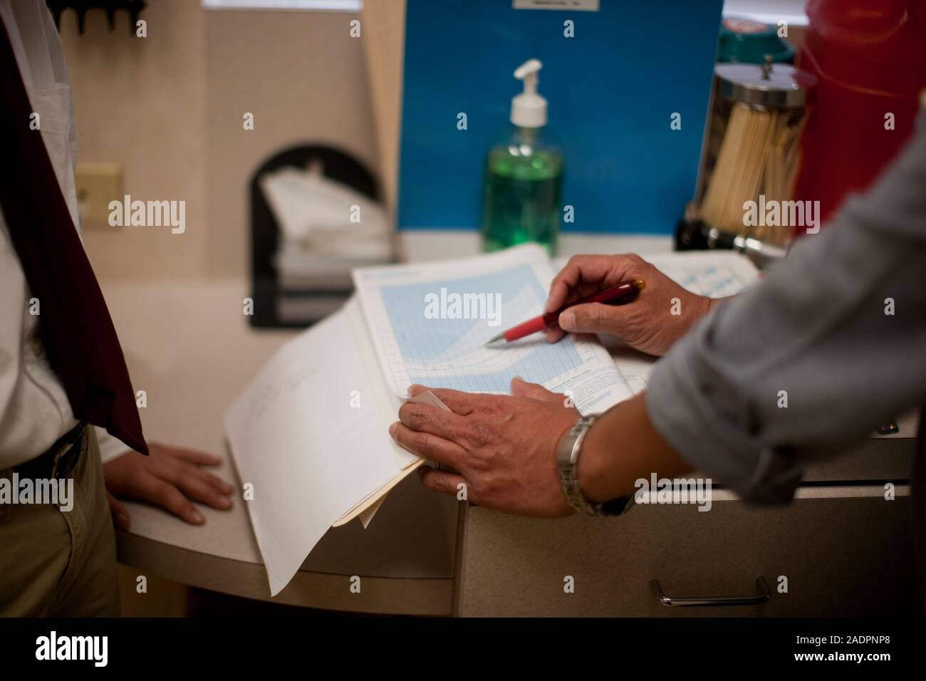 Doctor showing graph chart Stock Photo - Alamy