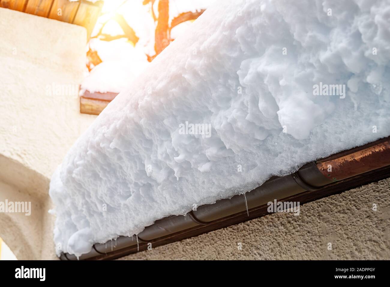 Roof of ancient stone building covered with thick snow drift layer ...