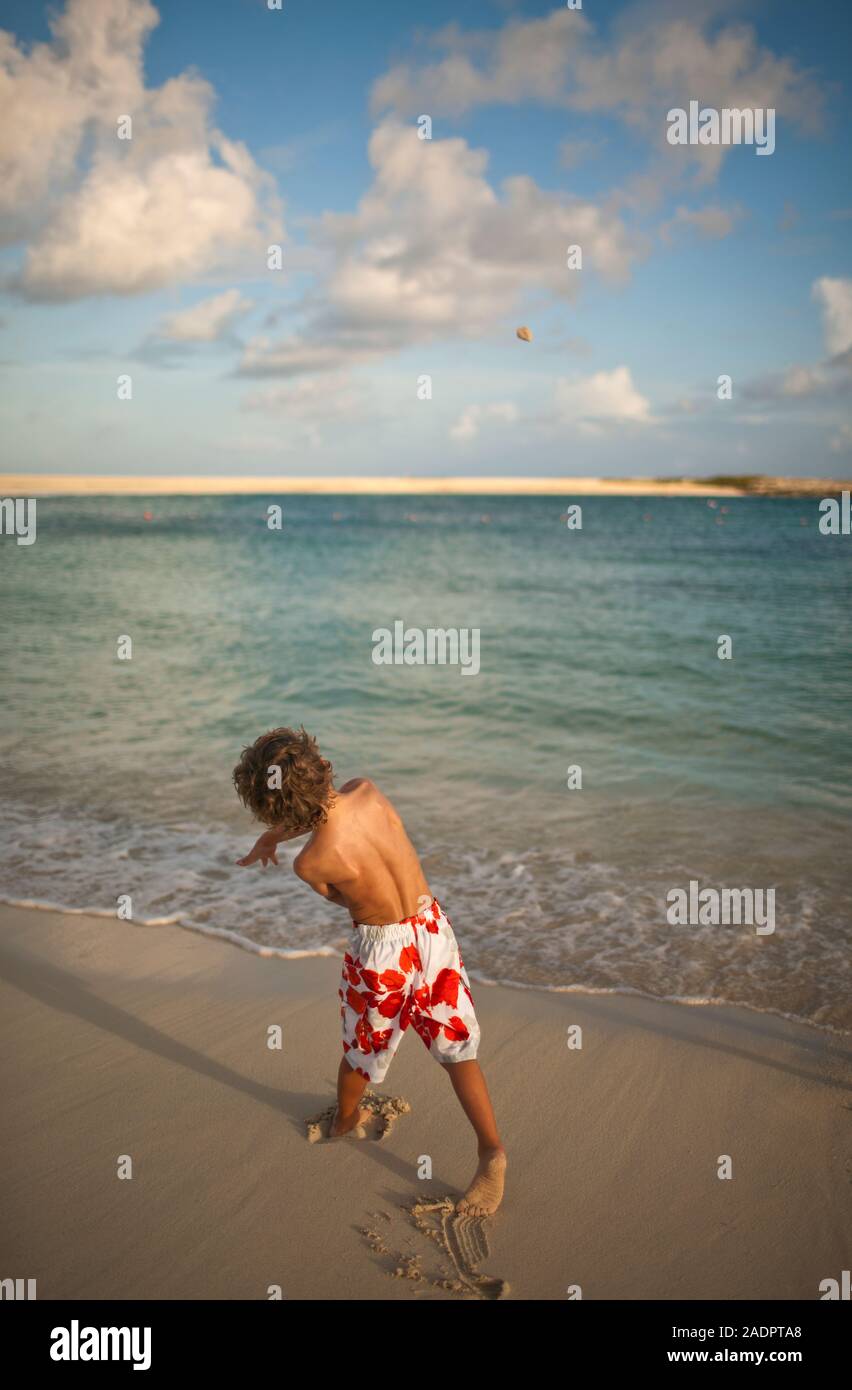 Boy throwing a stone by the sea hi-res stock photography and images - Alamy